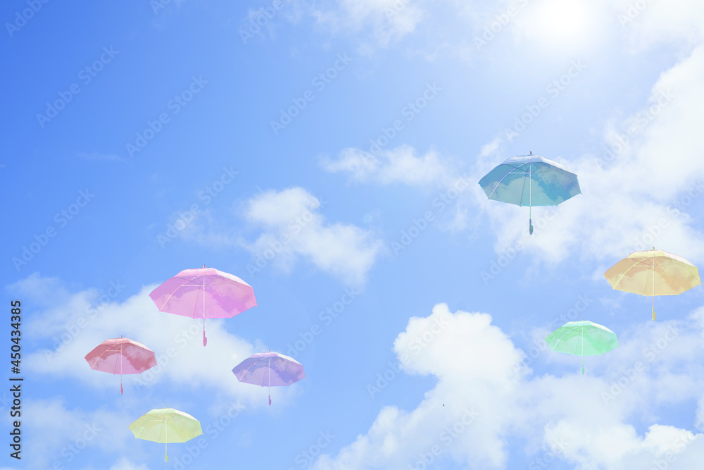 ภาพประกอบสตอก カラフルな空に浮かぶビニール傘の青空背景画像 晴れ 日差し 雨 アンブレラ ภาพ Adobe Stock