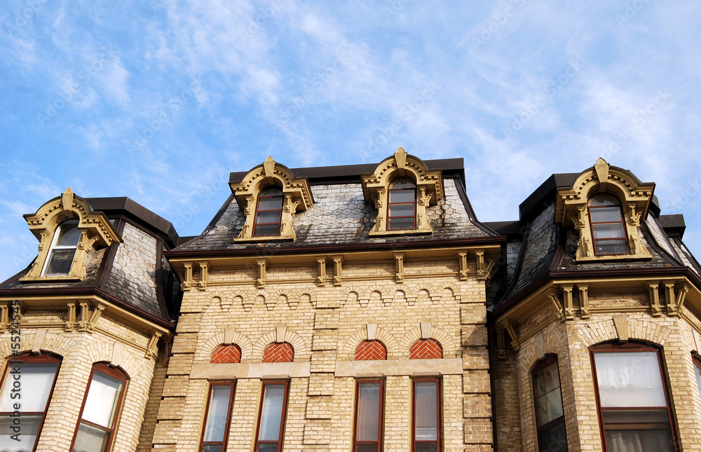 Yellow brick Victorian house with mansard roof and dormers Stock Photo ...