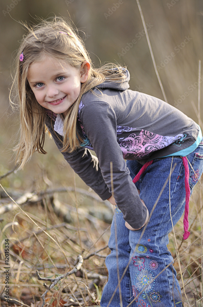 Little girl bending over Stock Photo | Adobe Stock