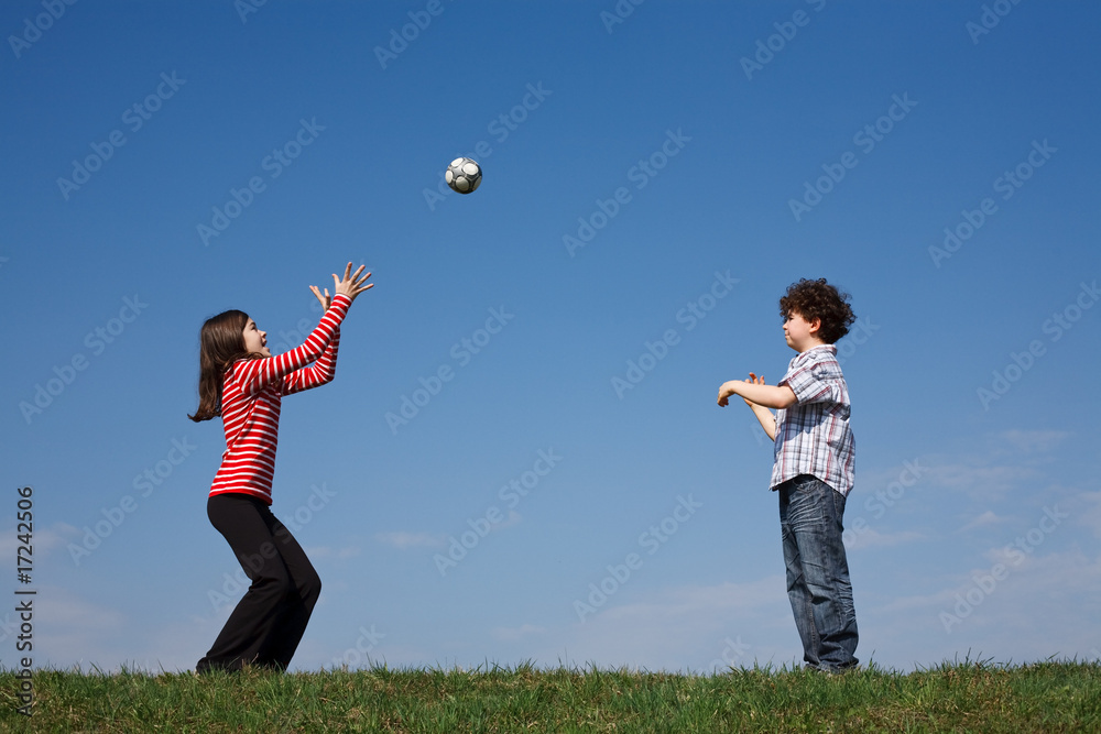 Kids playing ball outdoor against blue sky Stock Photo | Adobe Stock