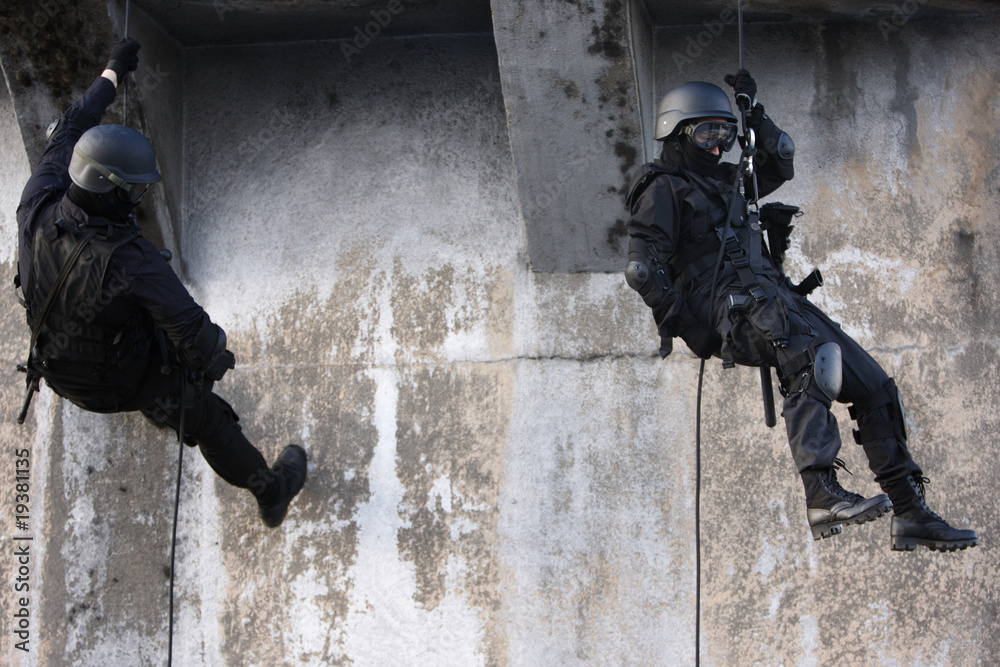 SWAT officers in full tactical gear. Stock Photo | Adobe Stock