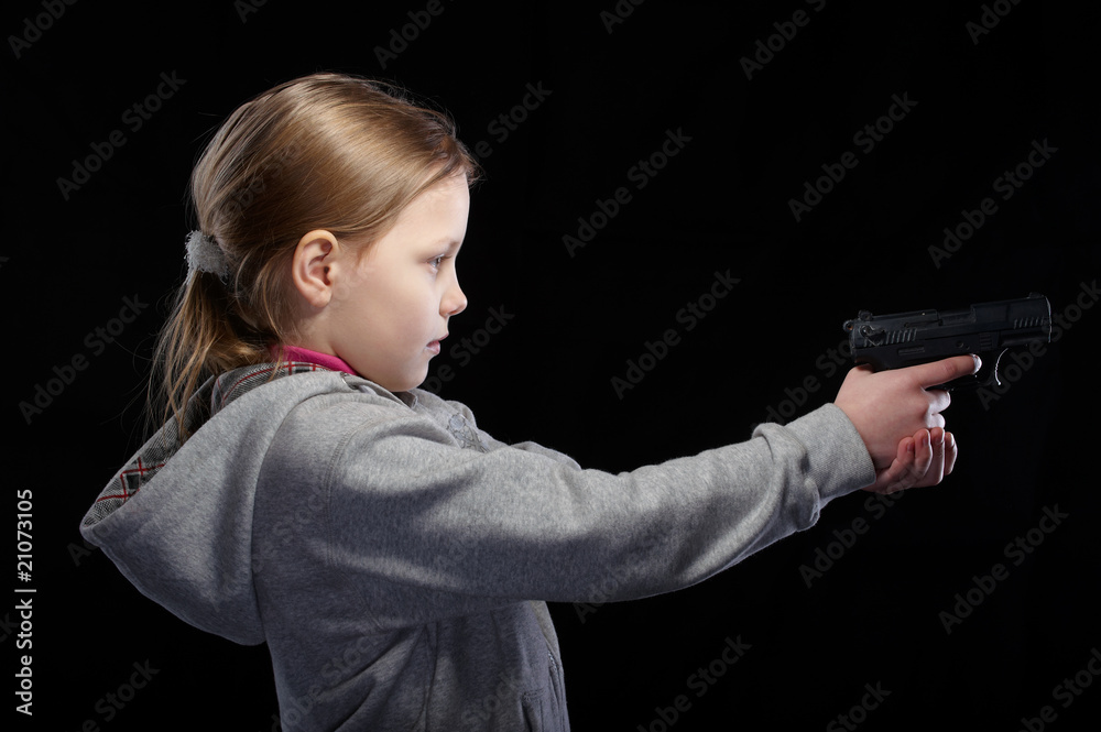 Little girl with gun Stock Photo | Adobe Stock