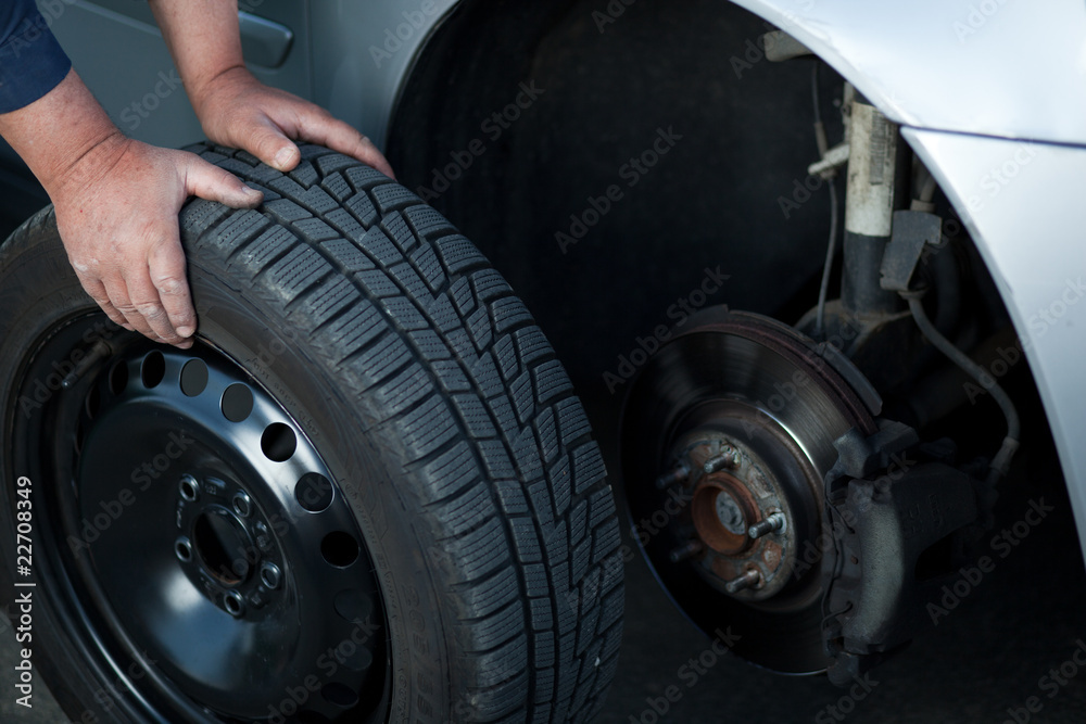 mechanic changing a wheel of a modern car (color toned image) Stock ...