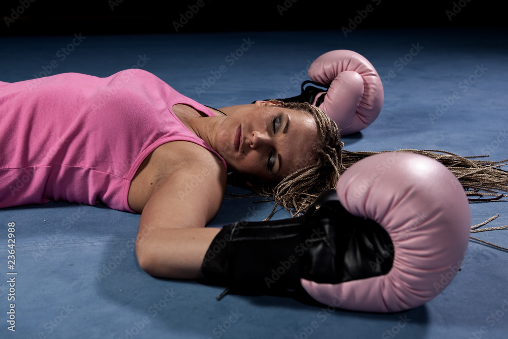 Blonde girl lying knocked out in a boxing ring Stock Photo | Adobe Stock