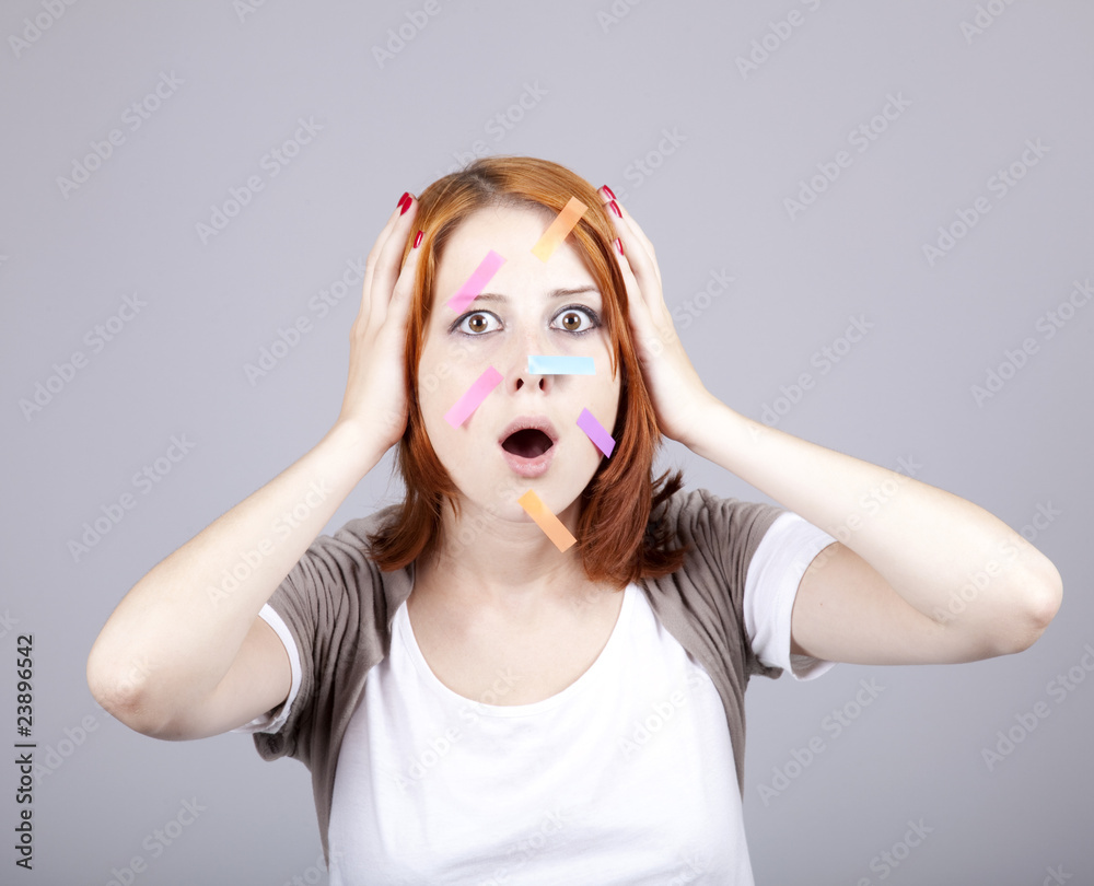 Confused red-haired businesswomen with notes on face. Stock Photo ...