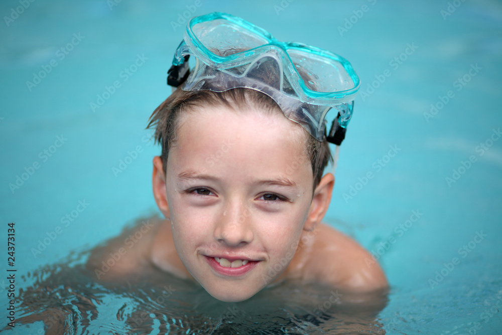 Boy smiling in swimming pool Stock Photo | Adobe Stock
