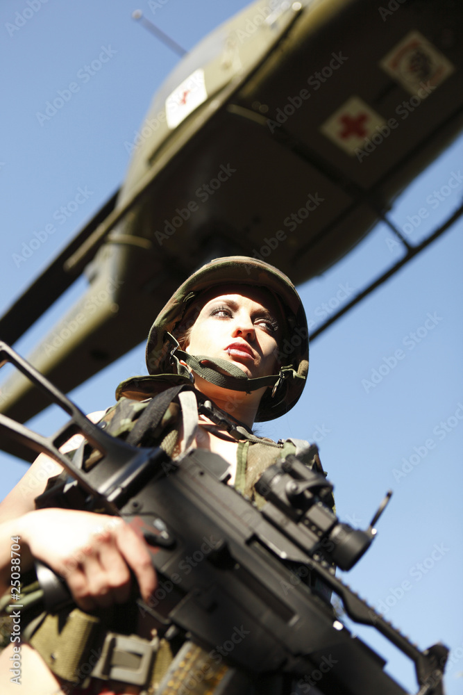Sexy female soldier with an assault rifle Stock Photo | Adobe Stock