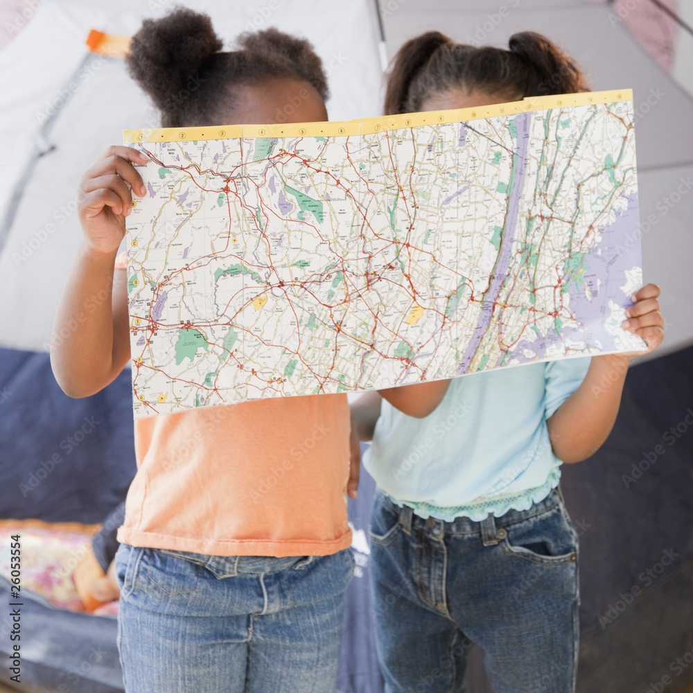 African girls looking at map Stock Photo | Adobe Stock
