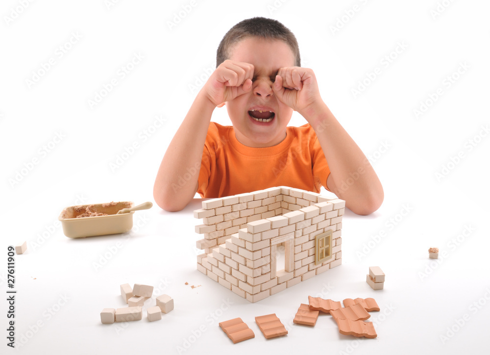 Little boy crying for his broken house. Stock Photo | Adobe Stock