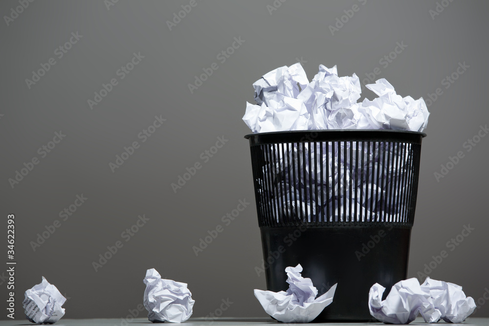 Recycle bin filled with crumpled papers Stock Photo | Adobe Stock