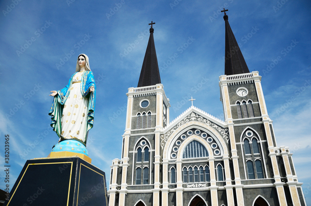 Virgin Mary statue with church background Stock Photo | Adobe Stock