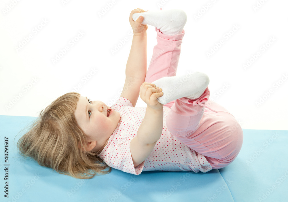 Smiling little girl doing sport exercises Stock Photo | Adobe Stock