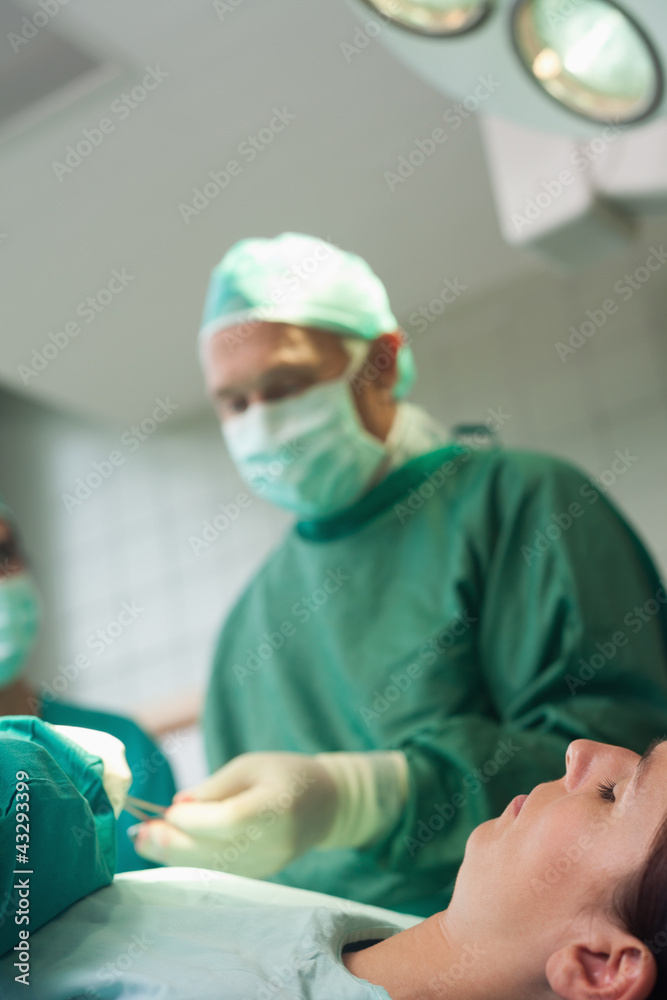 Patient sleeping on a surgical table while a surgeon is taking s Stock ...