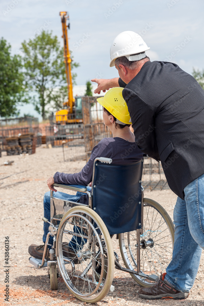 Architect shows disabled woman in wheelchair construction sites Stock ...