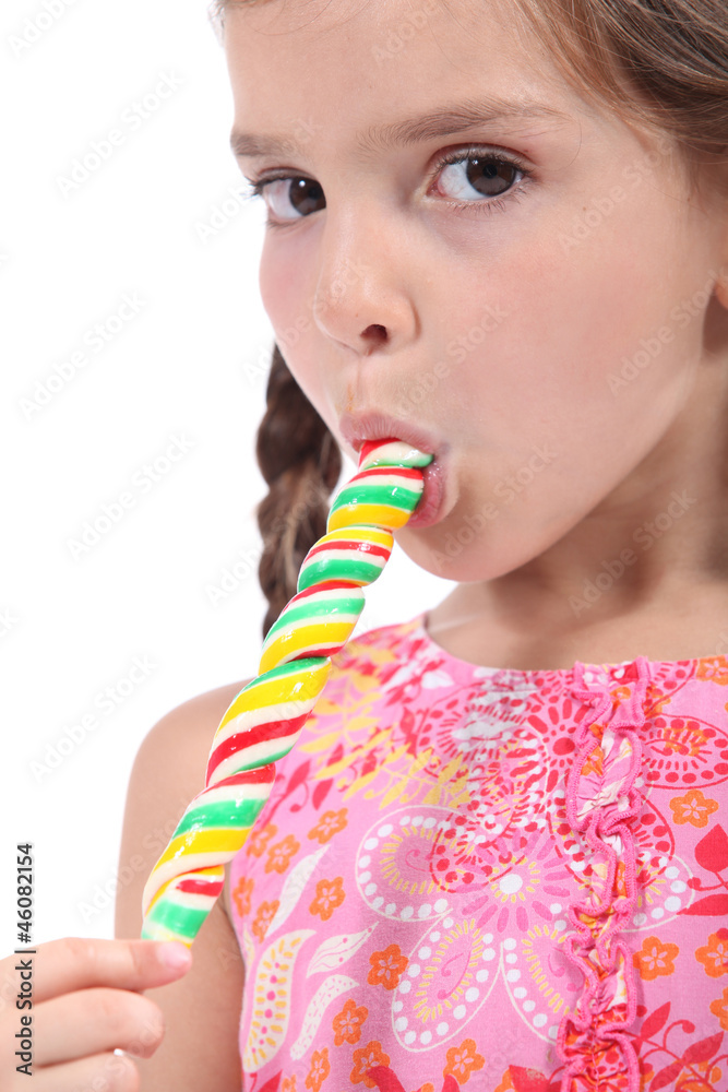 little girl licking a lollipop Stock Photo | Adobe Stock