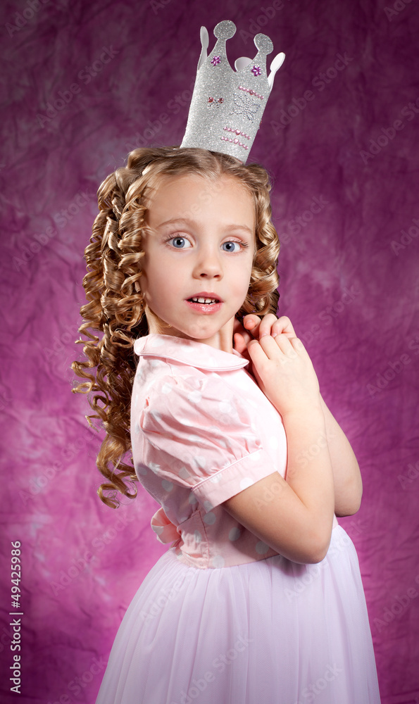 Little princess posing over dark pink background Stock Photo | Adobe Stock
