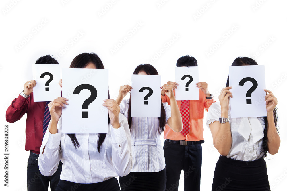 Colleagues holding question mark signs in front of their faces Stock ...