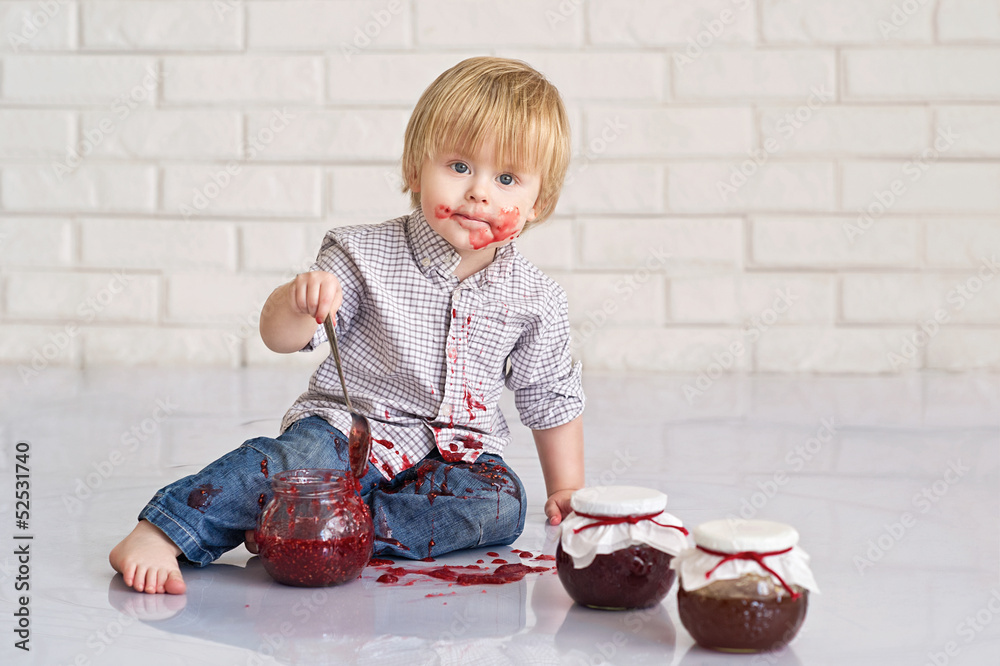 Funny little boy got messy eating strawberry jam Stock Photo | Adobe Stock