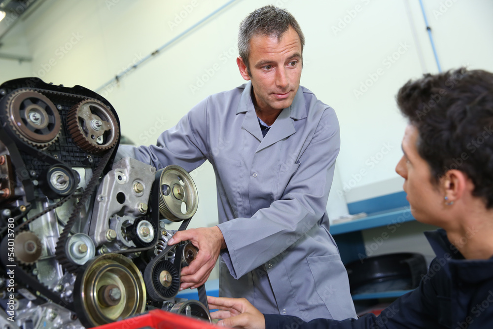 Professional trainer teaching student how to fix car engine Stock Photo ...
