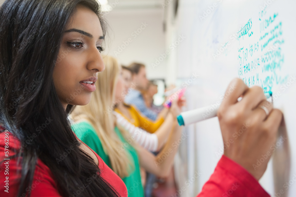 Students writing on the whiteboard in class Stock Photo | Adobe Stock