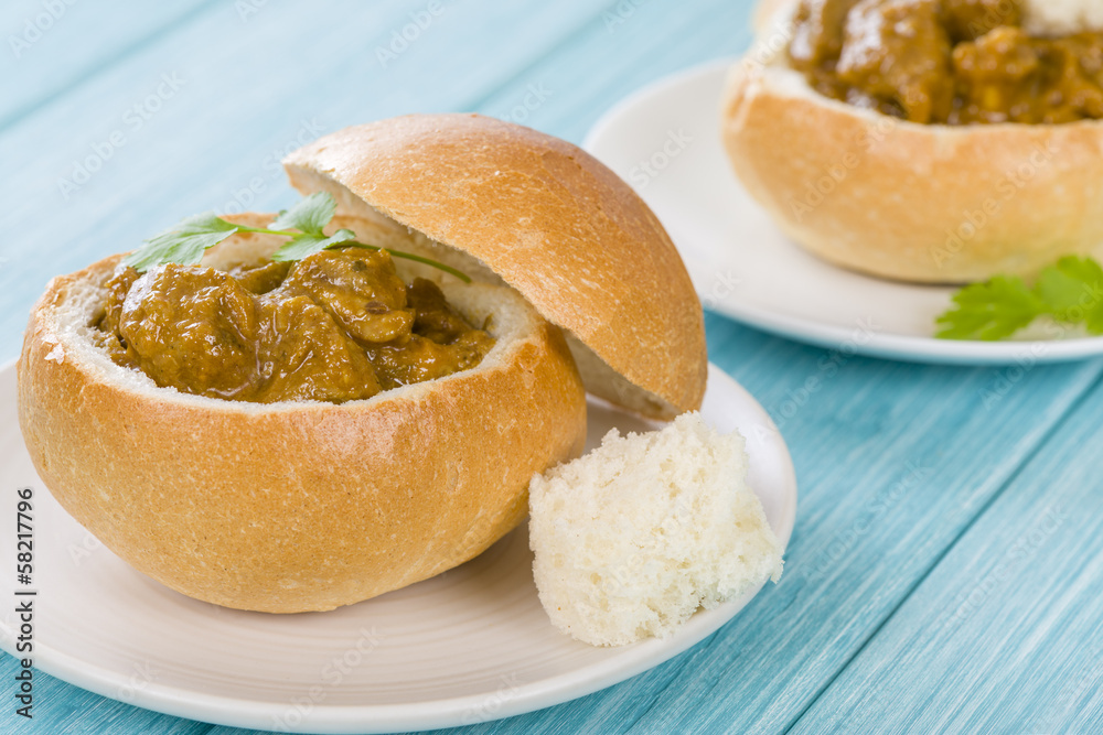 Bunny Chow - South African mutton curry inside a bread bun Stock Photo ...