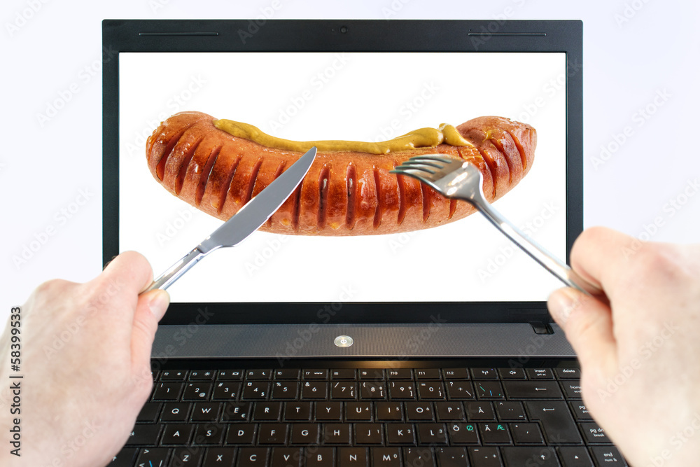 Stock-Foto „Man is eating virtual food from laptop screen“ | Adobe Stock