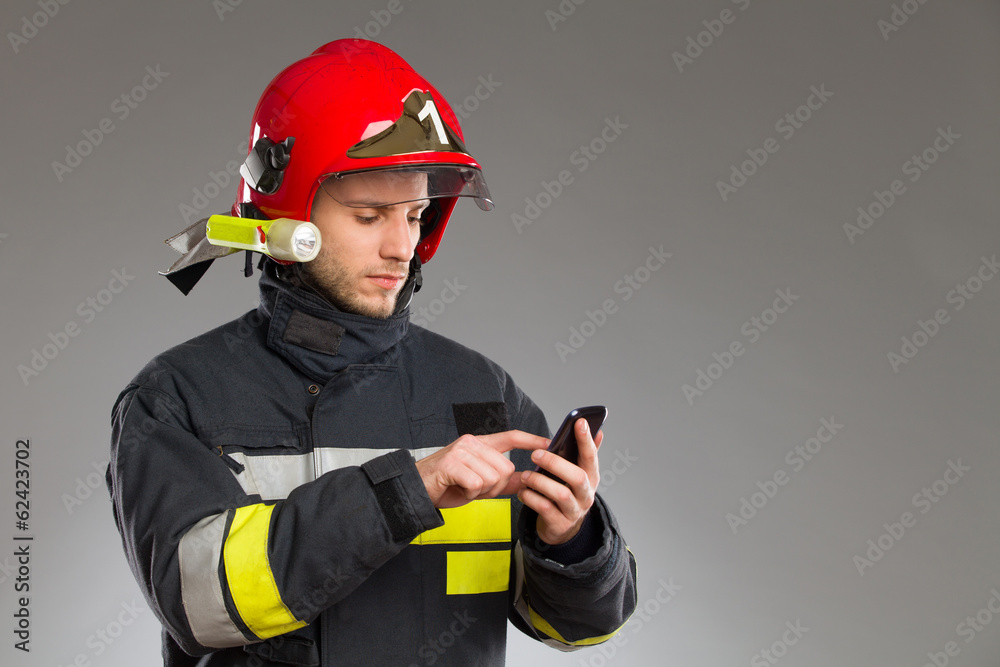 Firefighter using smart phone. Stock Photo | Adobe Stock
