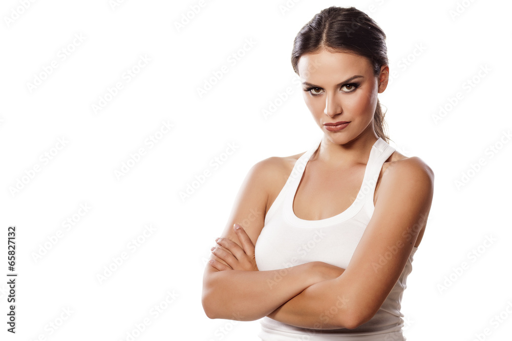 Photo Stock angry young woman with crossed arms on white background ...