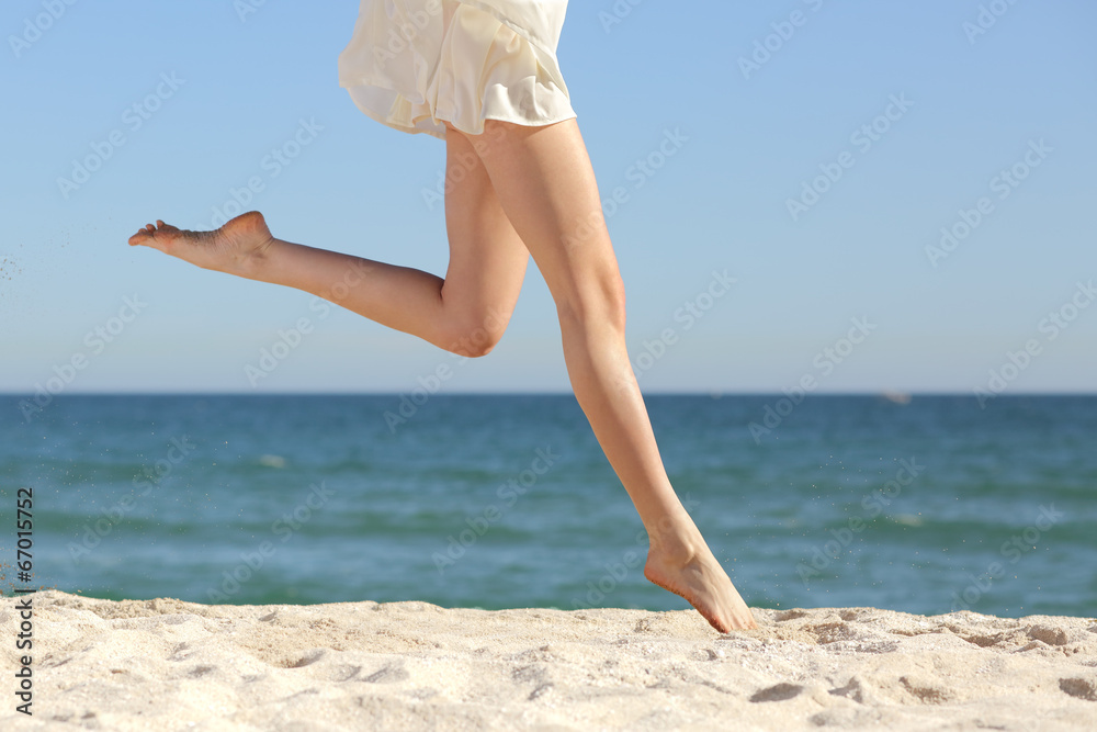 Beautiful woman long legs jumping on the beach Stock Photo | Adobe Stock