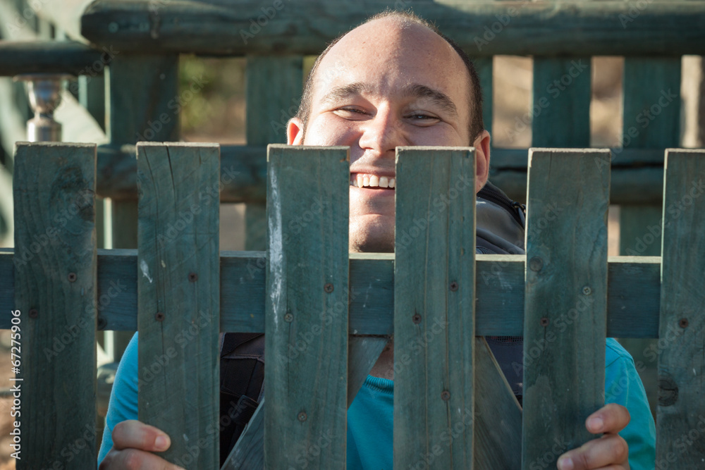 Happy man behind fence Stock Photo | Adobe Stock