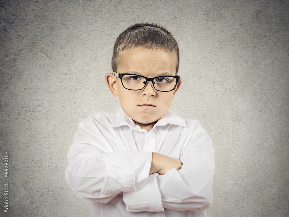 Stock-Foto „Portrait Angry, grumpy Boy with glasses on grey wall ...