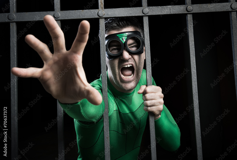 Superhero locked in prison Stock Photo | Adobe Stock