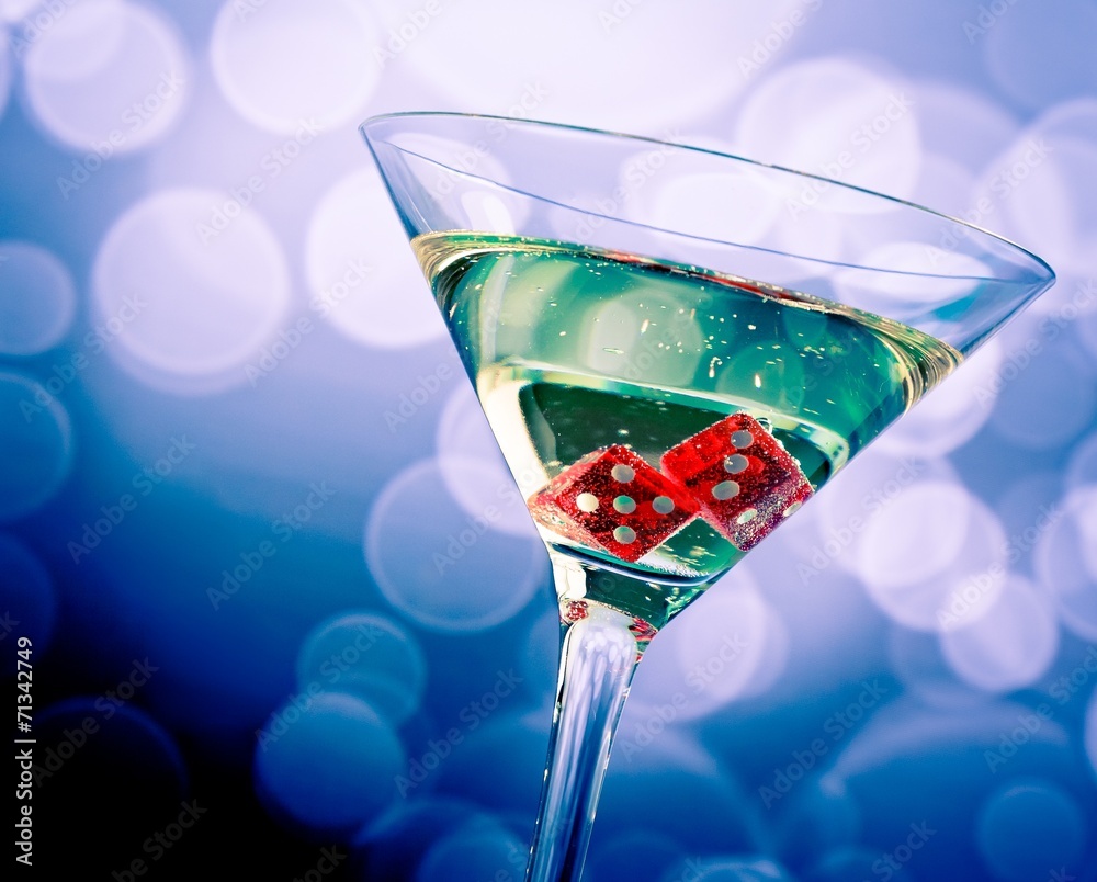 red dice in the cocktail glass on blue bokeh Stock Photo | Adobe Stock
