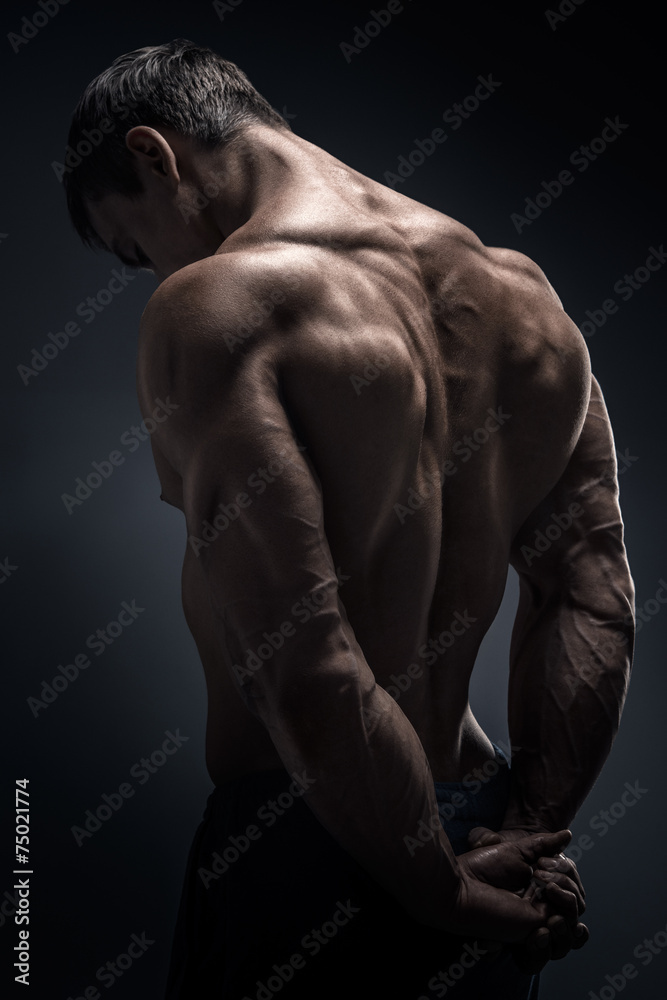 Handsome muscular bodybuilder turned back Stock Photo | Adobe Stock