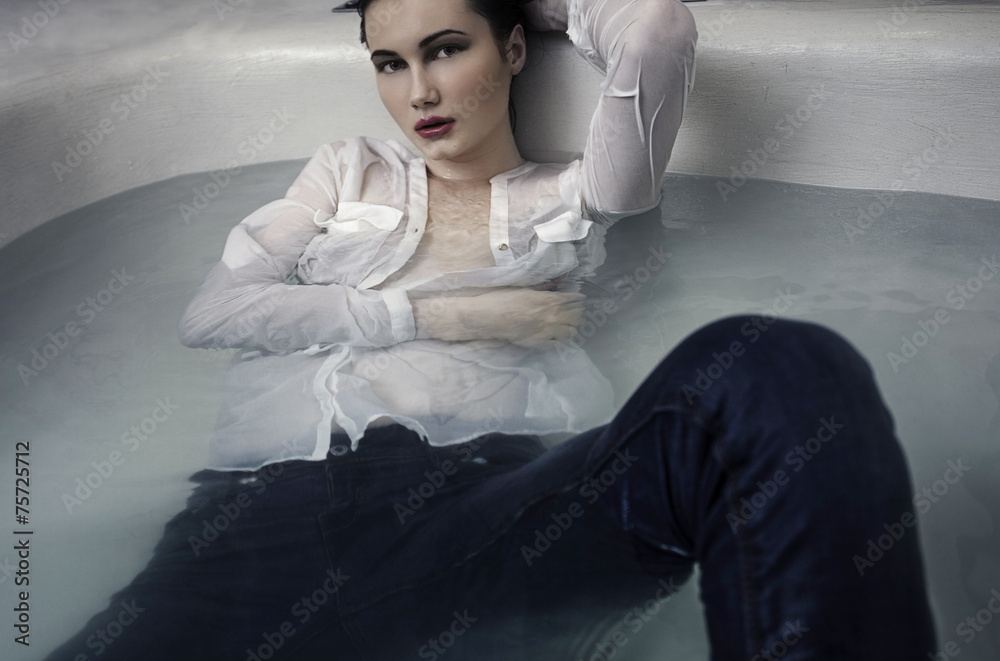 Sexy woman lying in a bath tub with her clothes on Stock Photo | Adobe ...