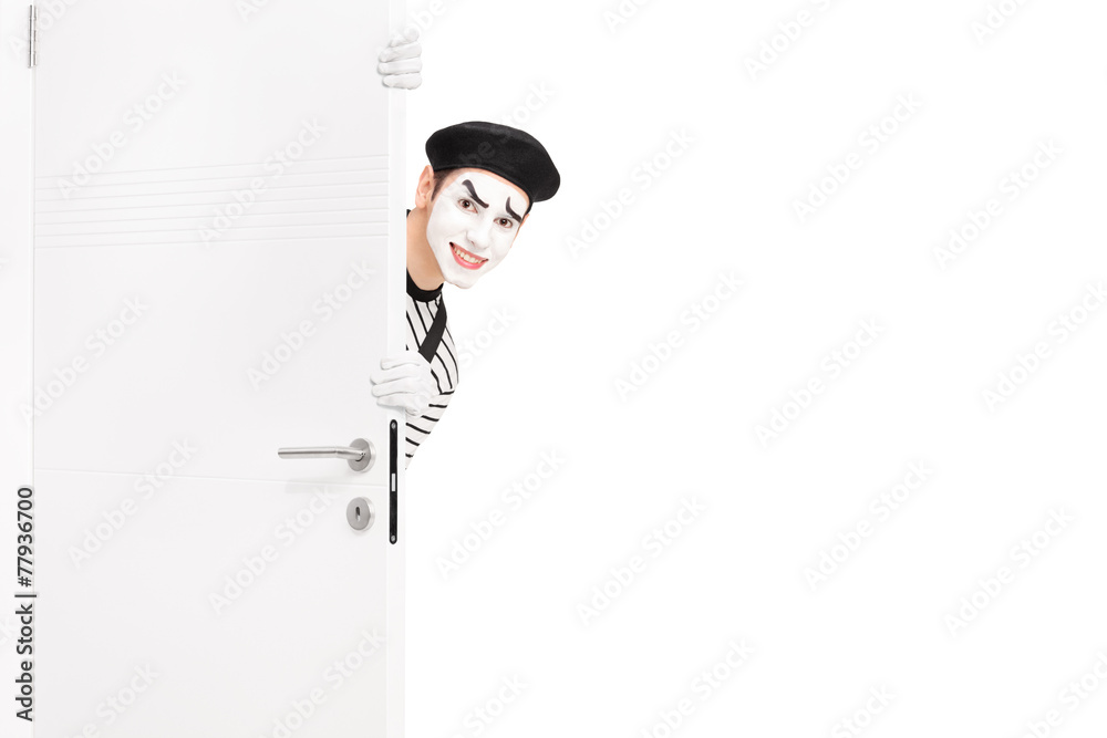 Smiling mime artist posing behind a wooden door Stock Photo | Adobe Stock