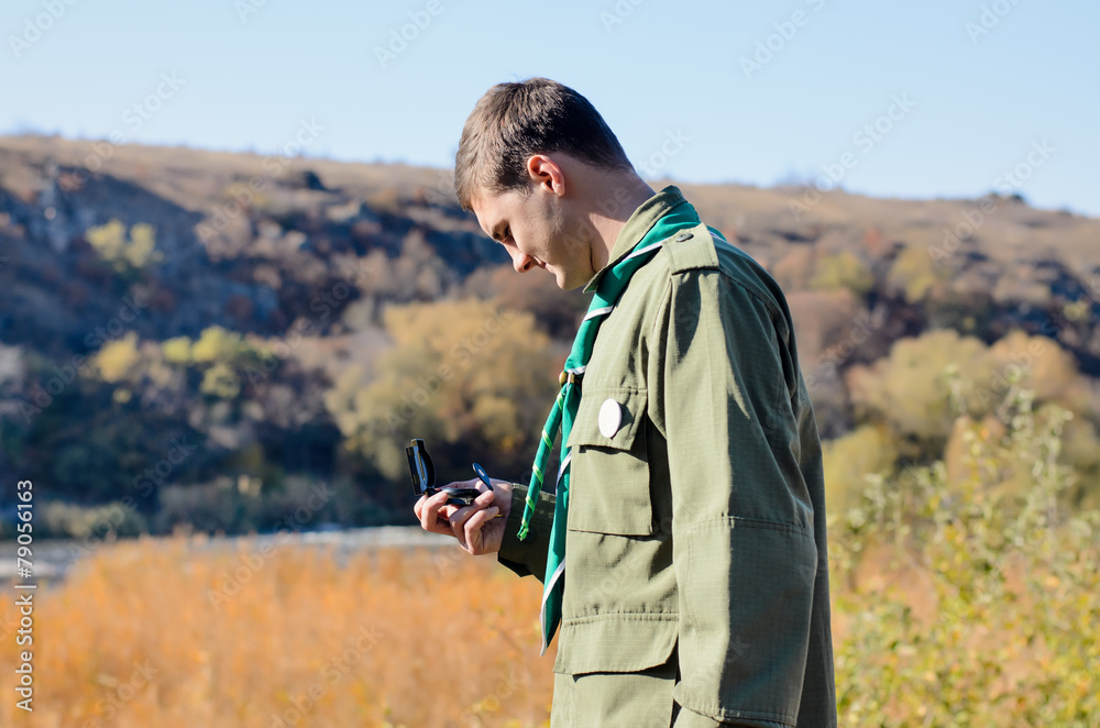 Scout master reading a compass outdoors Stock Photo | Adobe Stock