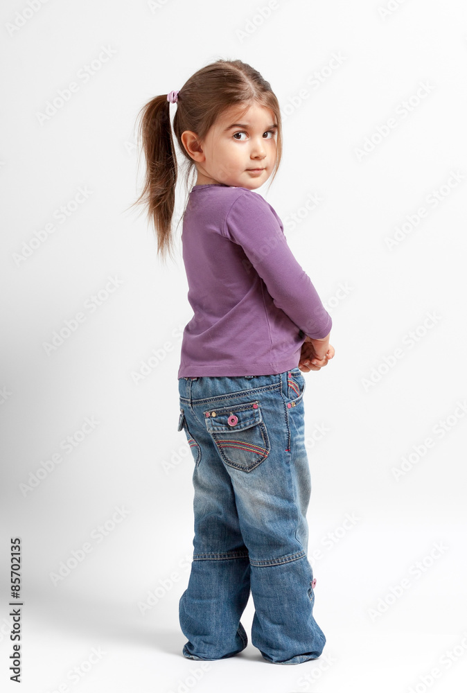 Cute little girl looking back Stock Photo | Adobe Stock