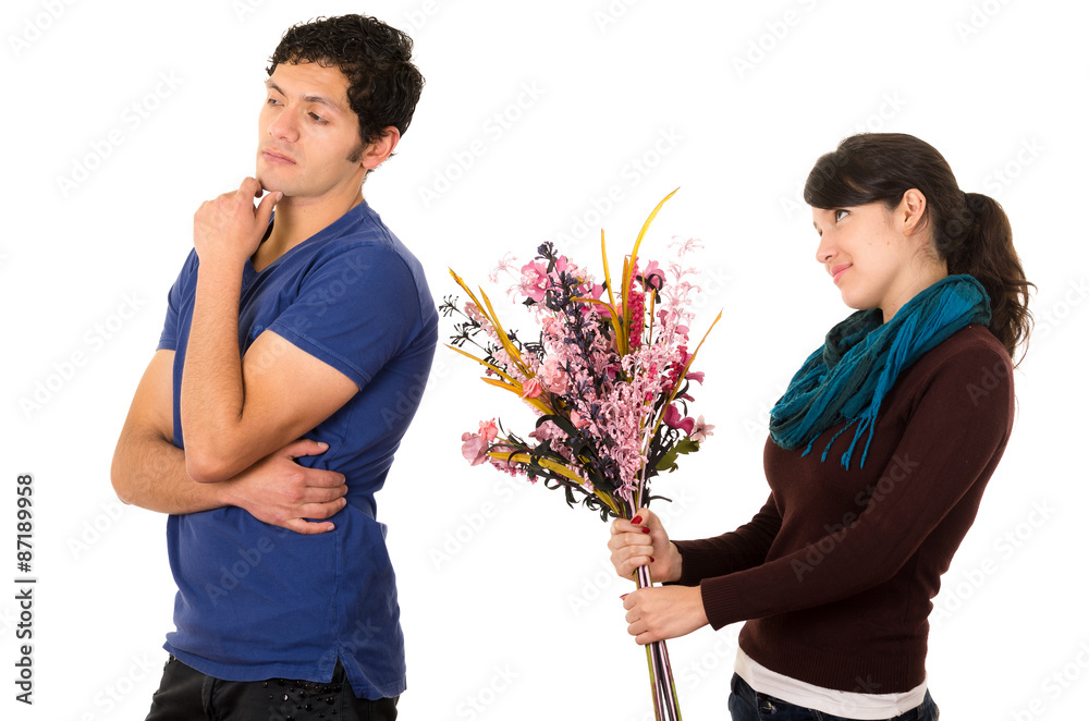 Woman holding flowers up behind mans back with hopeful expression and ...