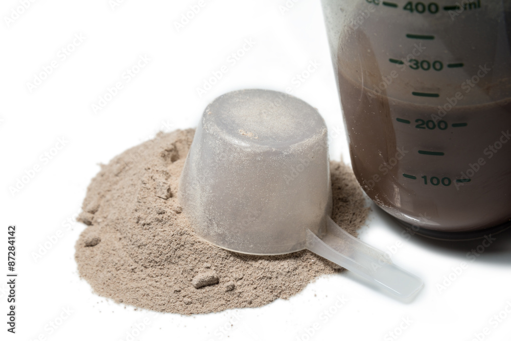 Chocolate protein shake with a upturned scoop poured protein pow Stock ...