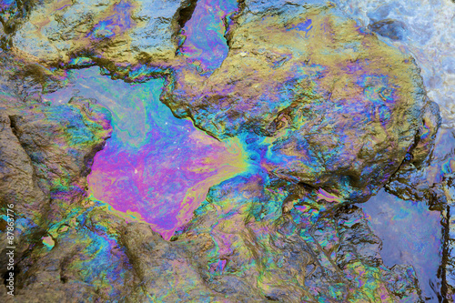 rainbow reflection of crude oil spill on the stone at the beach Stock ...