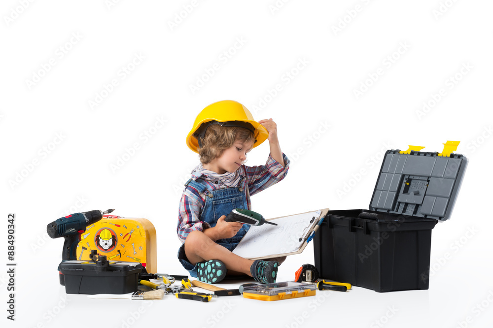 Little boy dressed as utility worker with protective helmet trying to ...