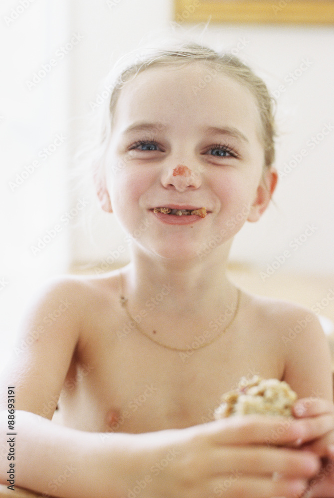 Nude Young Girl Eating A Sandwich With Crumbs In Her Mouth And Tomato Sauce On Her Nose