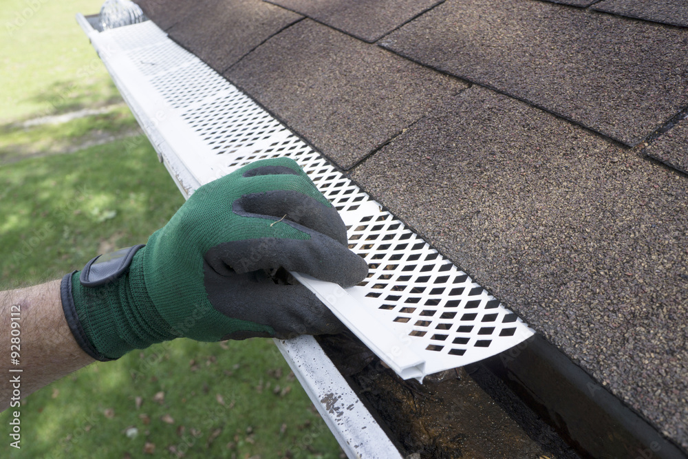 Contractor Adjusting Plastic Gutter Guards Stock Photo | Adobe Stock