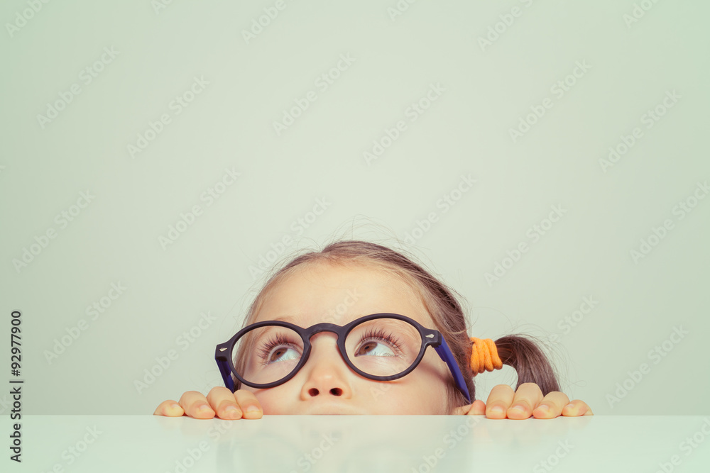 cute little girl hiding behind the table Stock Photo | Adobe Stock
