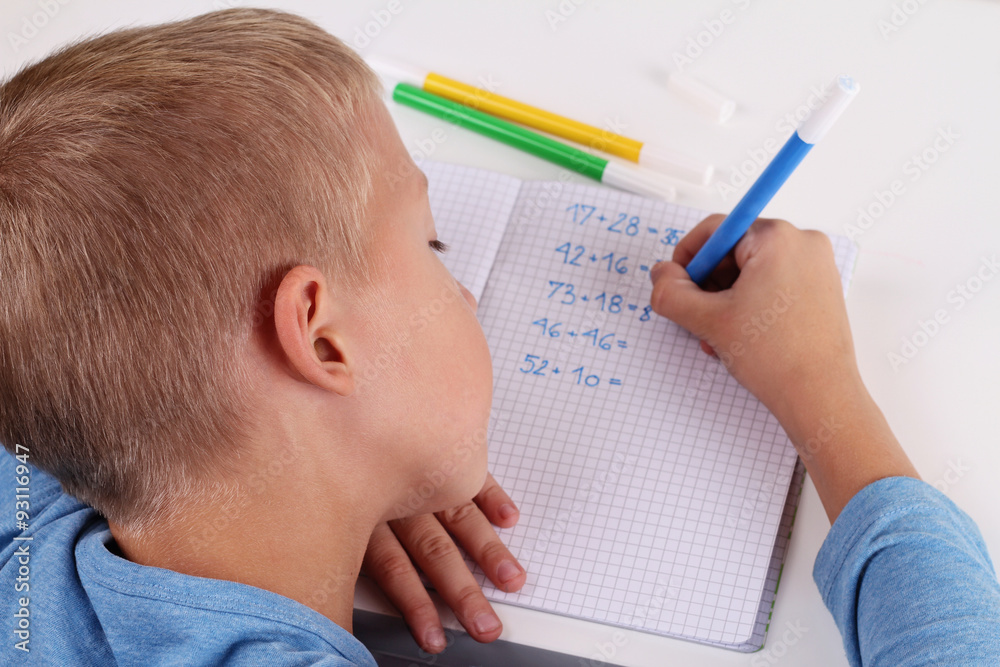 8 year old elementary school age boy does math homework. Kids ...
