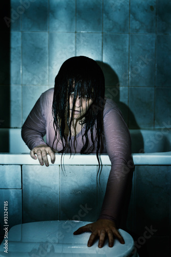 Scary woman in a bath coming out of the water all wet, Halloween and ...