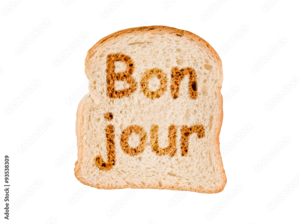 Word bonjour (meaning good morning in French) written on a toasted ...