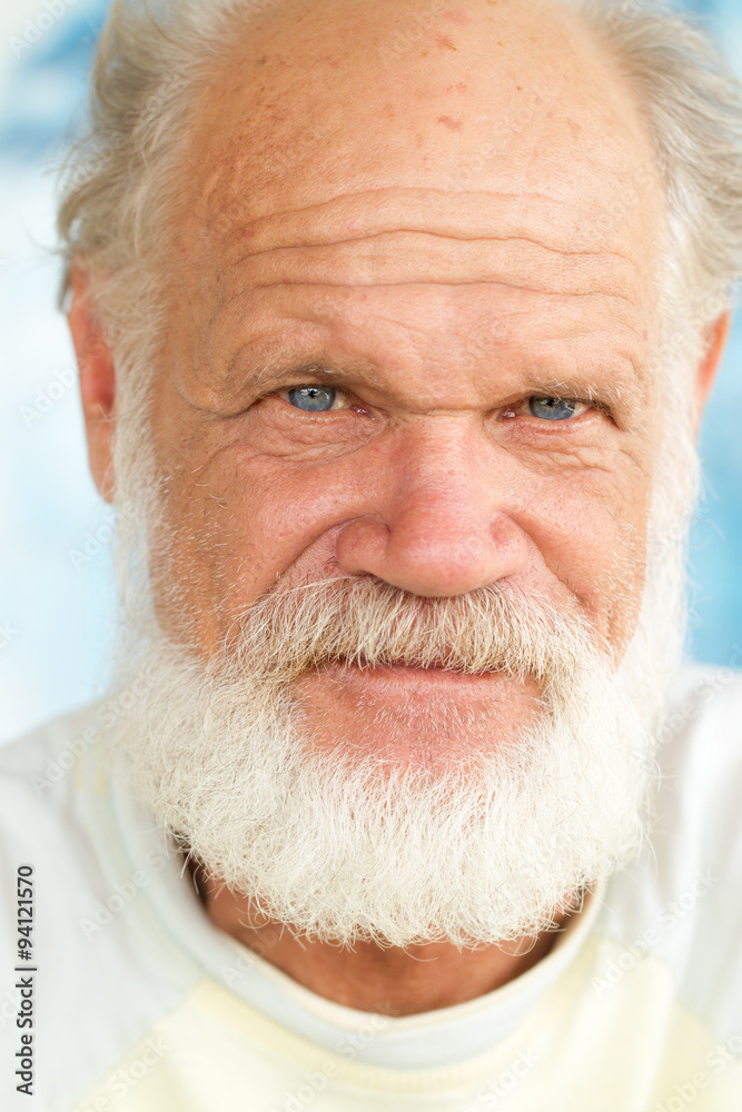 An old, white-haired, bald man with a beard and mustache, close-up on ...
