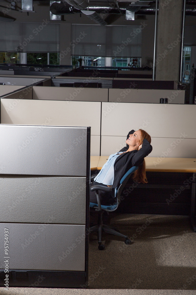 Office woman leaning back in her cubicle Stock Photo | Adobe Stock